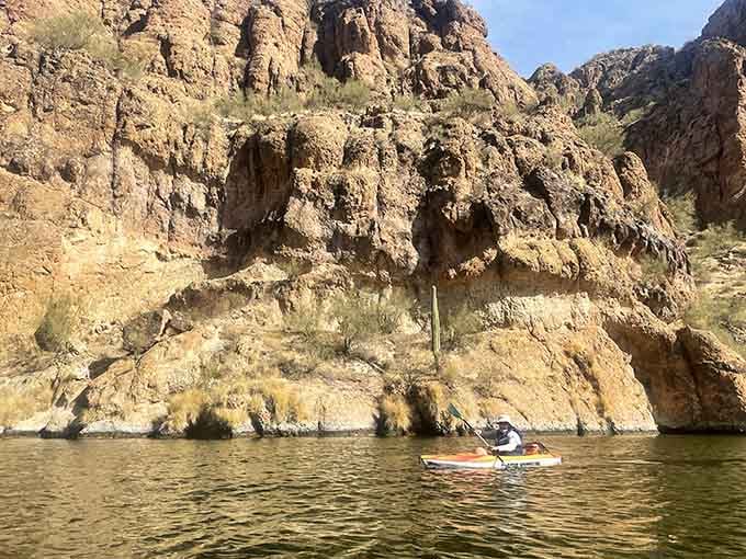 Those canyon walls have been standing for millennia, patiently waiting for glowing kayaks to show up and steal the show.