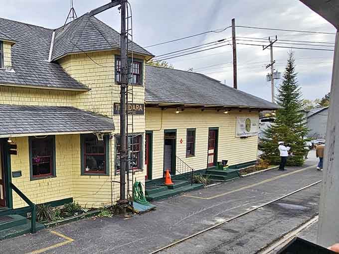Thendara Station's charming yellow exterior welcomes travelers at the end of their scenic mountain journey.