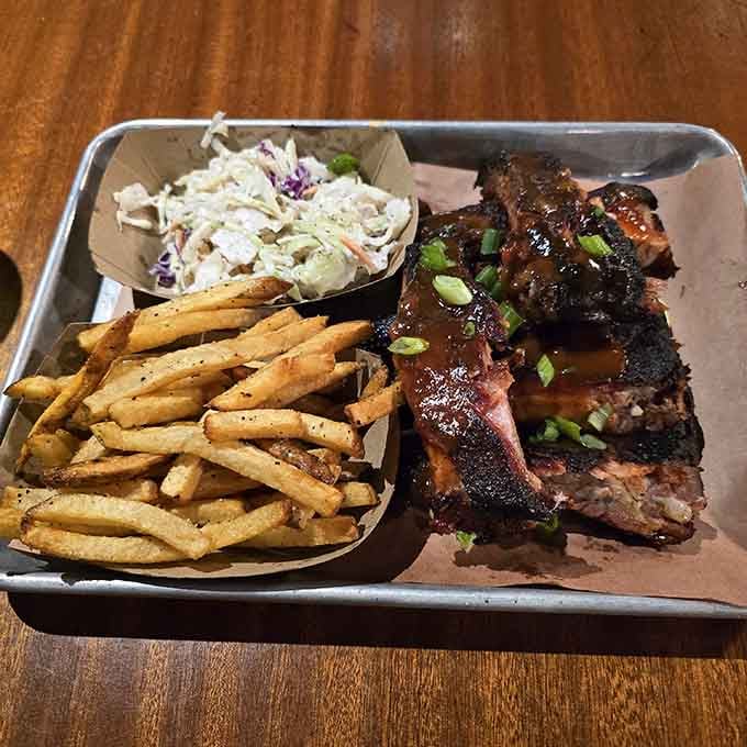 Ribs, fries, and slaw on a tray: the holy trinity of barbecue happiness in its natural habitat.