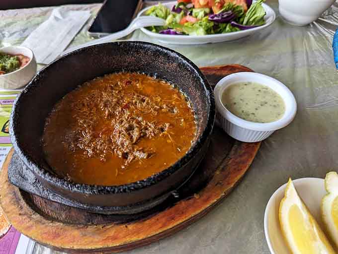 Fahsa arrives sizzling in a hot stone pot, bubbling with tender meat that's worth every careful spoonful.