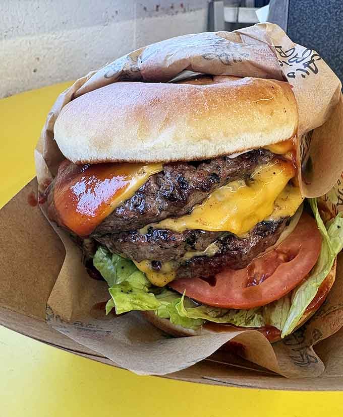 Two patties stacked high with melted cheese cascading down like a delicious dairy waterfall of joy.