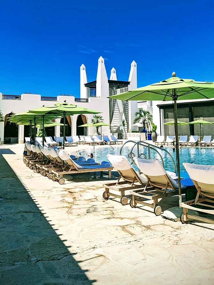 That pool setup with the bright umbrellas is basically saying "bring your book and cancel all your afternoon plans."