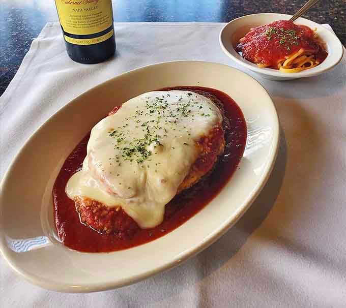 Melted mozzarella cascading over breaded chicken like a delicious avalanche you'll never want to escape from.