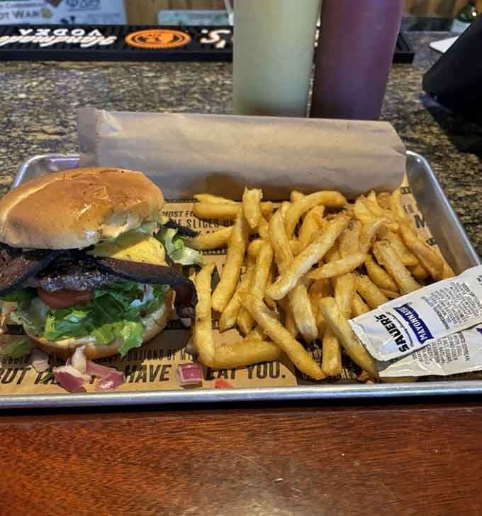 Behold the burger that made AL.com voters believers, stacked high with bacon and served with fries golden as Alabama sunshine.