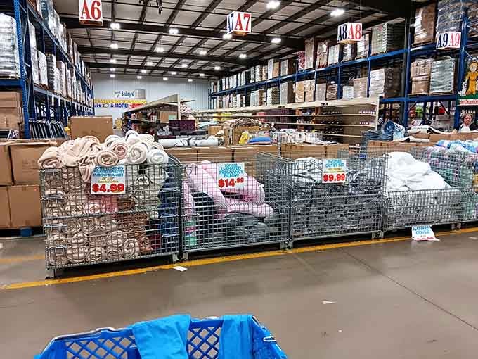 Bins overflowing with bedding create a textile treasure hunt where luxury linens hide among everyday essentials at remarkable savings.