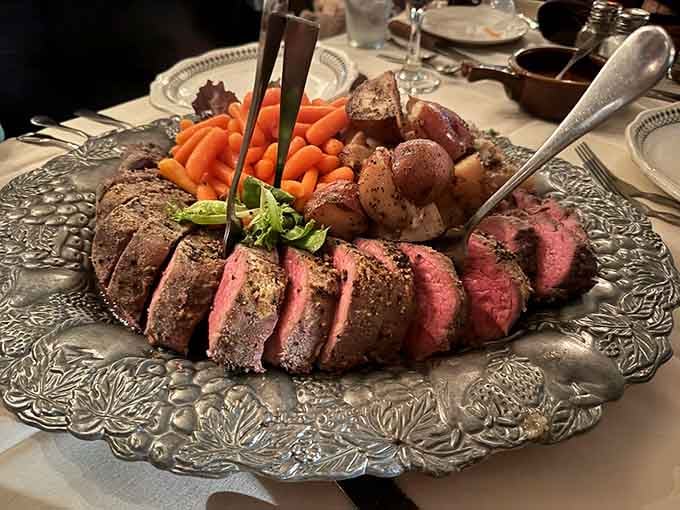 Chateaubriand served on an ornate silver platter with roasted vegetables proves elegance never goes out of style.