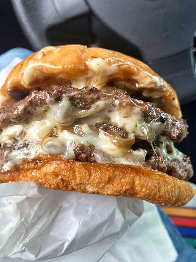 Three patties of pure joy stacked so high it makes the Leaning Tower of Pisa look stable.