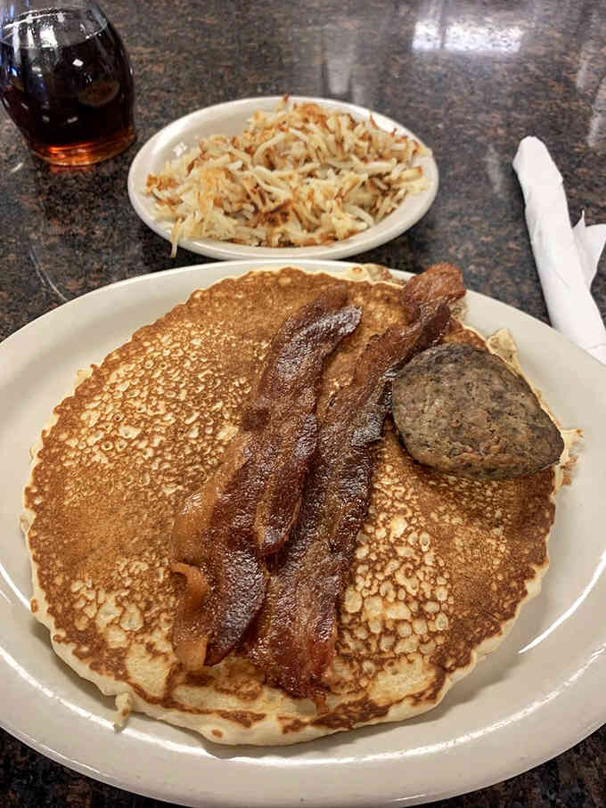 Pancakes the size of hubcaps with bacon and sausage that'll make you forget every diet you've ever attempted.