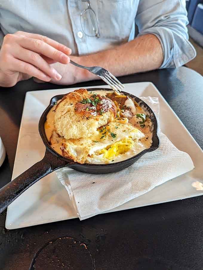 Behold the star of the show: biscuits drowning in sausage gravy, served in a skillet like edible treasure.