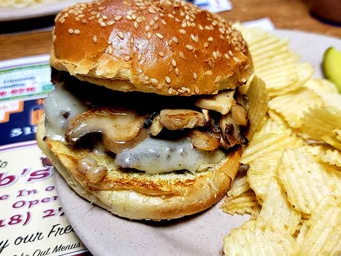 Behold the Mushroom Swiss Burger on a sesame seed bun, proving that some combinations are simply meant to be.