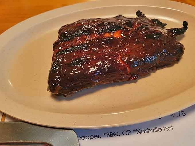 These ribs have that mahogany glaze that makes grown adults consider licking their plates when nobody's watching.