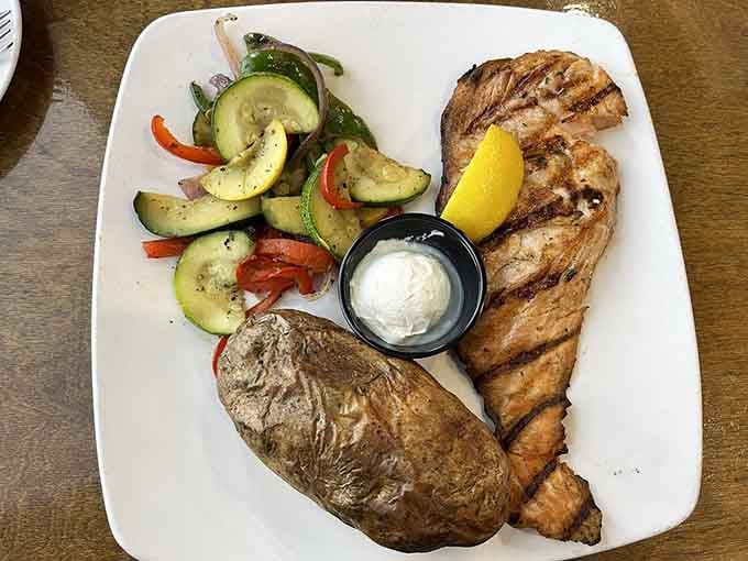 Perfectly grilled salmon paired with a loaded baked potato proves simple done right beats fancy every time.