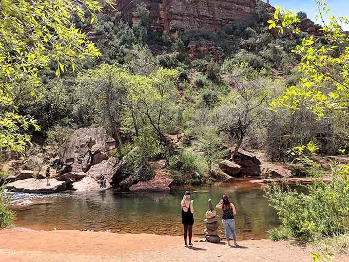 Two friends contemplate whether the water's cold enough to make them regret this decision, spoiler alert: it's worth it.