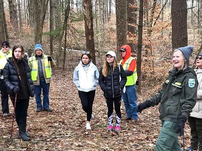 A ranger shares trail secrets with eager hikers who look ready to conquer every path in sight.