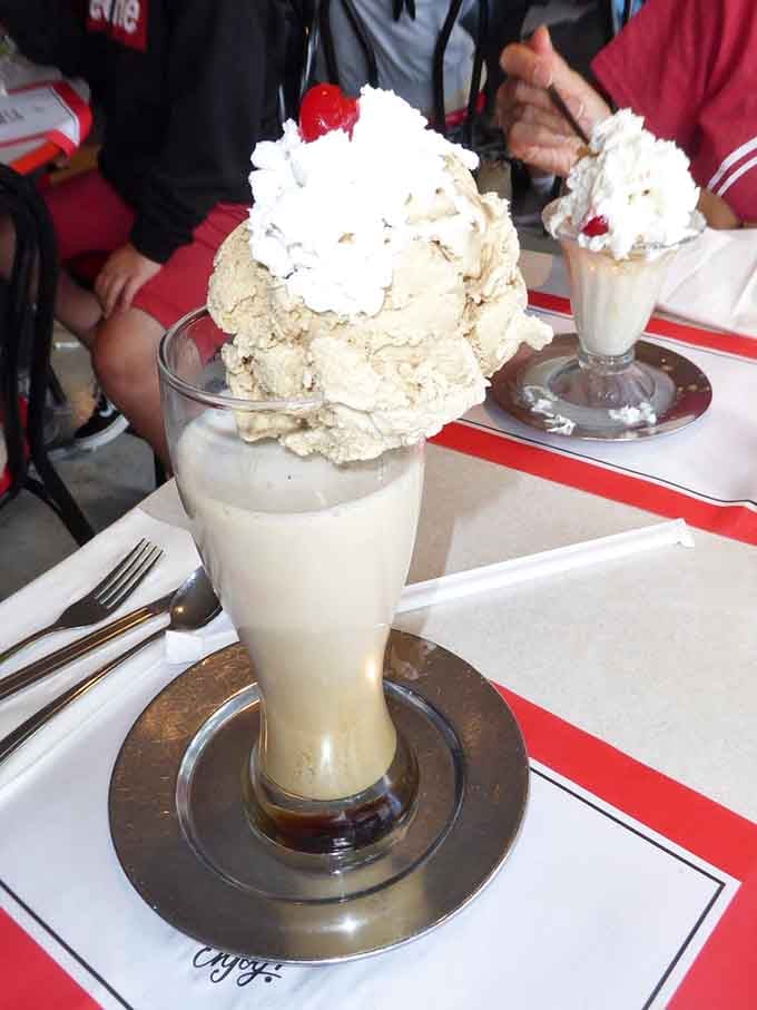That towering ice cream soda defies gravity and common sense in the most delicious way possible.