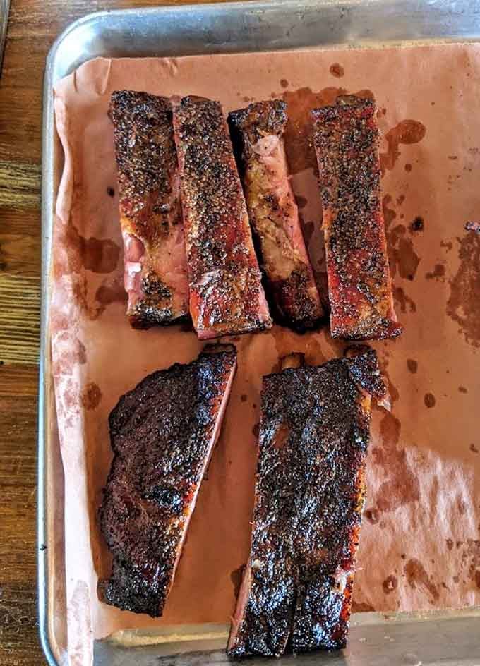 These ribs showcase that perfect bark and smoke ring that barbecue dreams are made of, ready for their close-up.