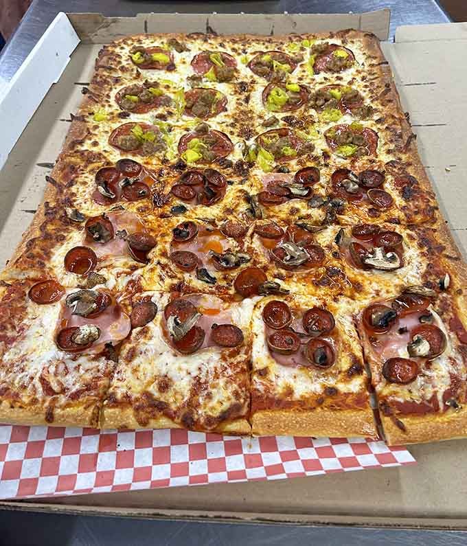 Behold the beast: a rectangular pizza so massive it makes regular pies look like appetizers at a dollhouse dinner party.