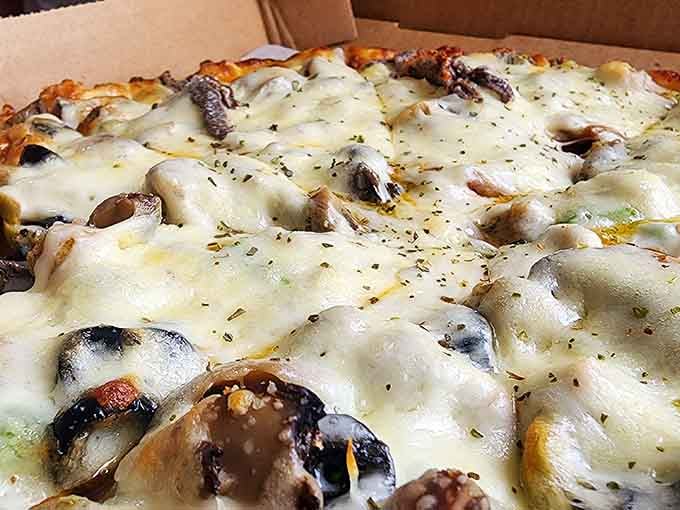 This mushroom-loaded masterpiece proves that sometimes more is definitely more when it comes to pizza toppings.