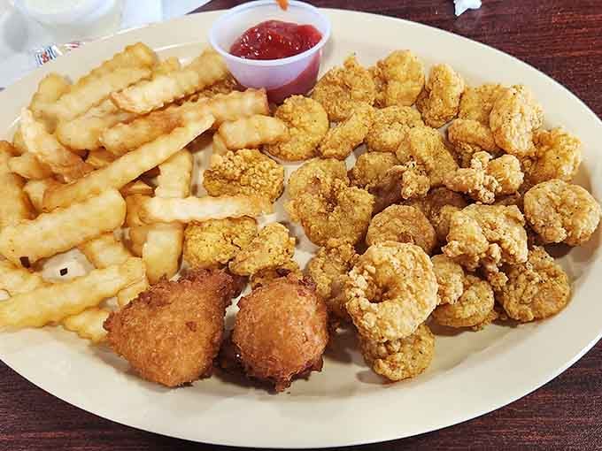 Golden fried shrimp and hush puppies piled high enough to make your cardiologist schedule an intervention meeting.