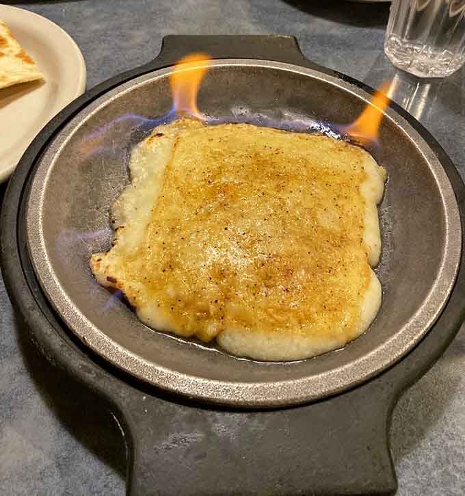 Flaming cheese at your table because sometimes dinner needs a little drama and a lot of melted goodness.