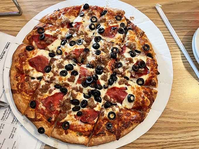Loaded with pepperoni, sausage, black olives, and cheese, this pizza is what dreams are made of, folks.