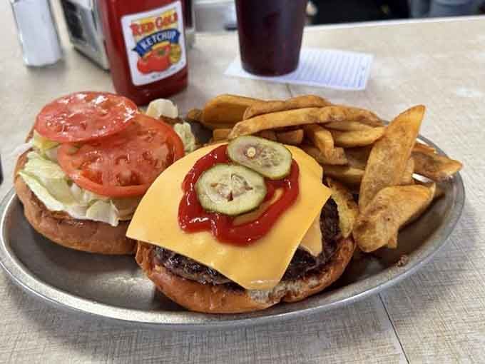 Behold the deluxe cheeseburger: crispy edges, melted cheese, and enough fries to share if you're feeling generous.