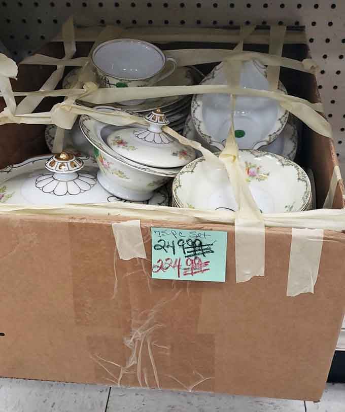 Delicate china pieces bundled together like a grandmother's prized collection waiting for someone who'll appreciate them.