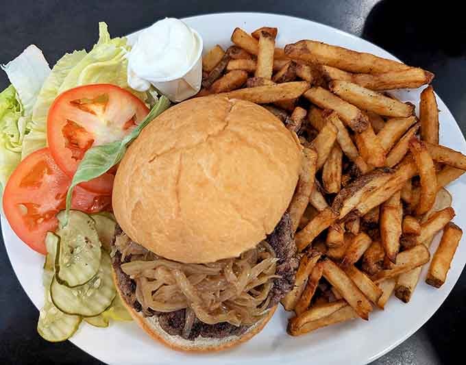 Behold the burger that launched a thousand return visits, complete with fries that deserve their own fan club.