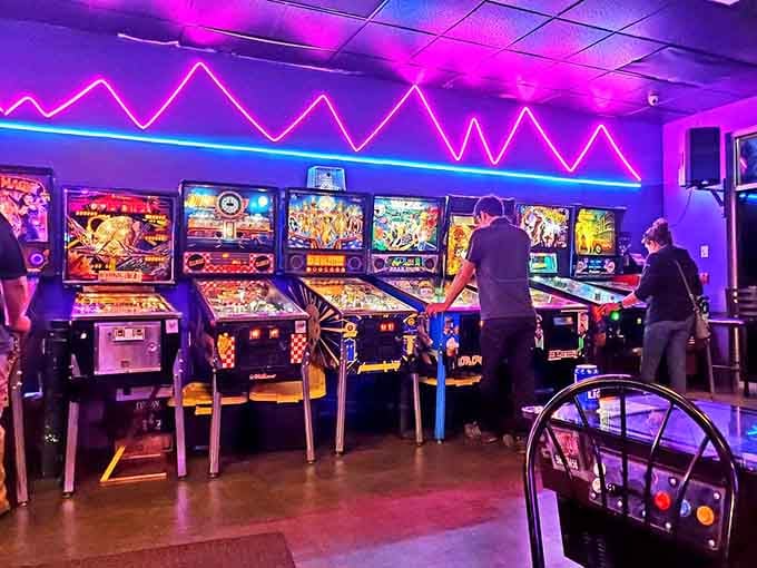 The pinball machines stand at attention like chrome soldiers, ready to drain your... well, not quarters anymore.