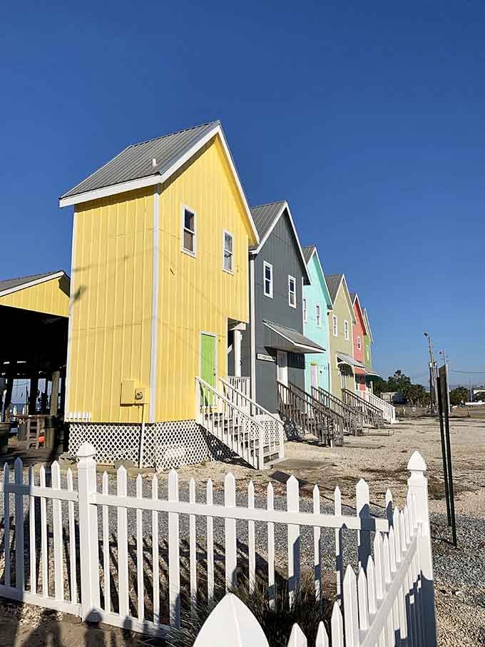 These cheerful cottages look like a box of crayons decided to retire by the beach.