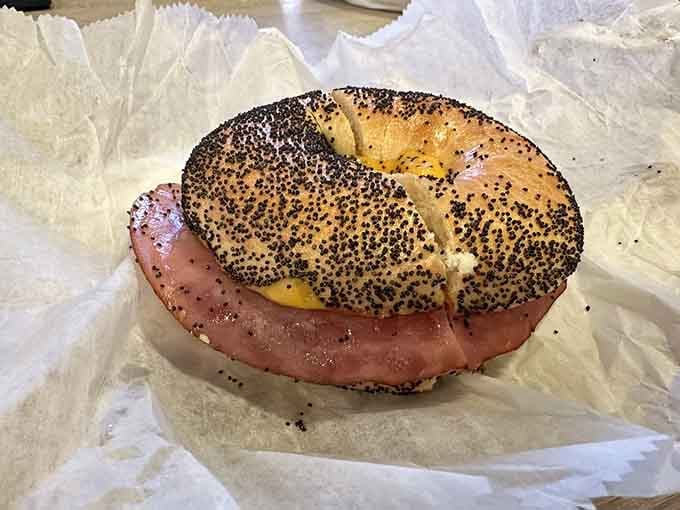 This ham, egg, and cheese situation on a poppy seed bagel could solve most of life's problems.