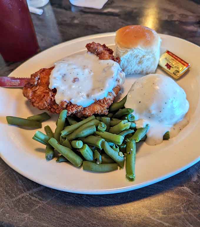 Chicken fried steak smothered in gravy with green beans proves some traditions deserve to live forever and ever.