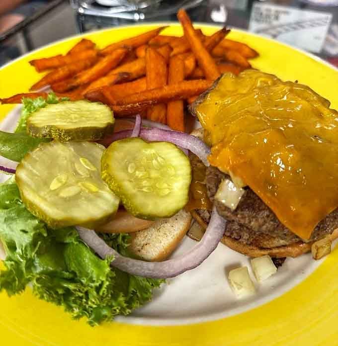 That cheese is melting like it's auditioning for a food commercial, and those sweet potato fries aren't playing around either.