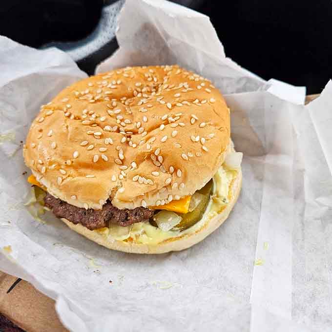 Behold the sesame seed crown jewel: a burger that laughs in the face of portion control.