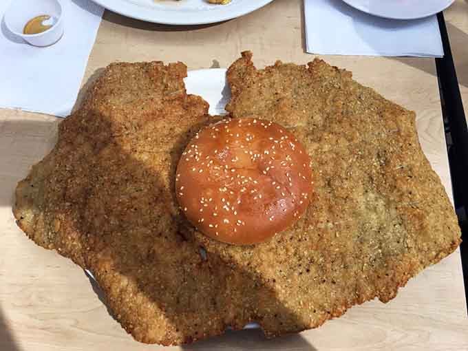 Behold the tenderloin in all its golden glory, making that bun look like it wandered into the wrong neighborhood.