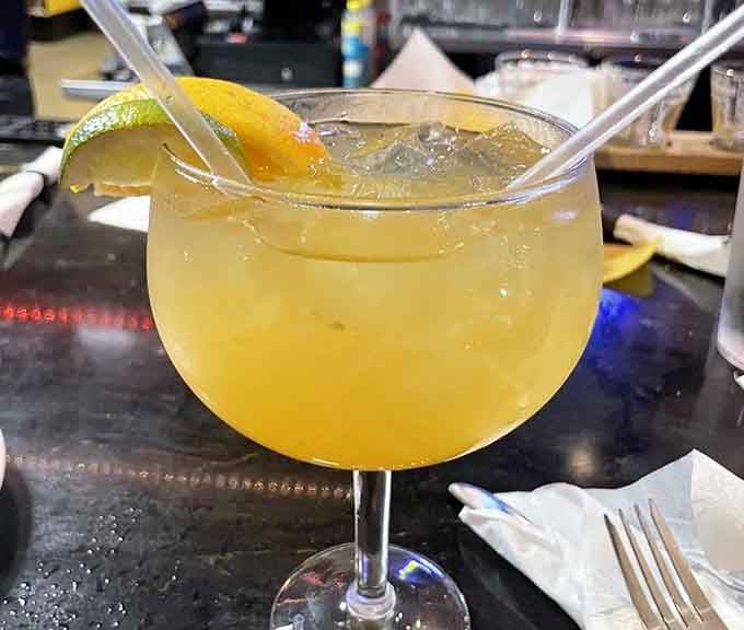 That margarita's so big it could double as a birdbath, and honestly, the birds would be jealous of you.