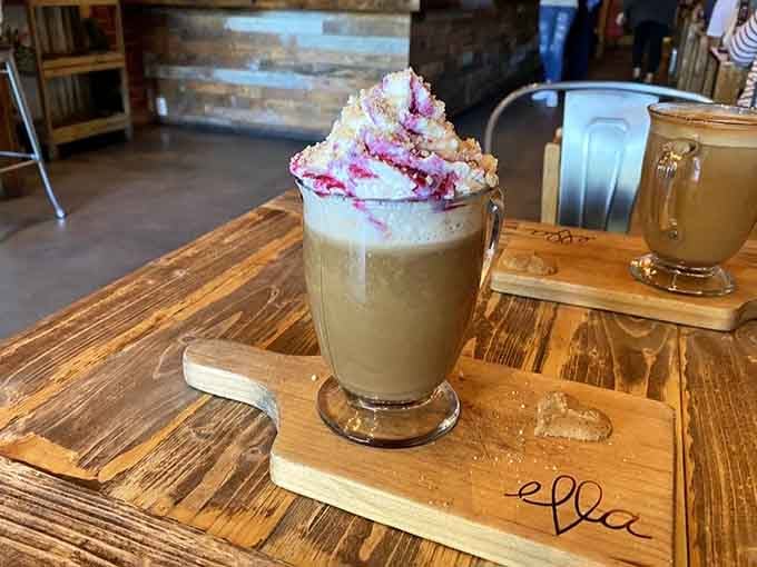 This isn't just a latte, it's what happens when someone decides whipped cream and berry drizzle deserve center stage.