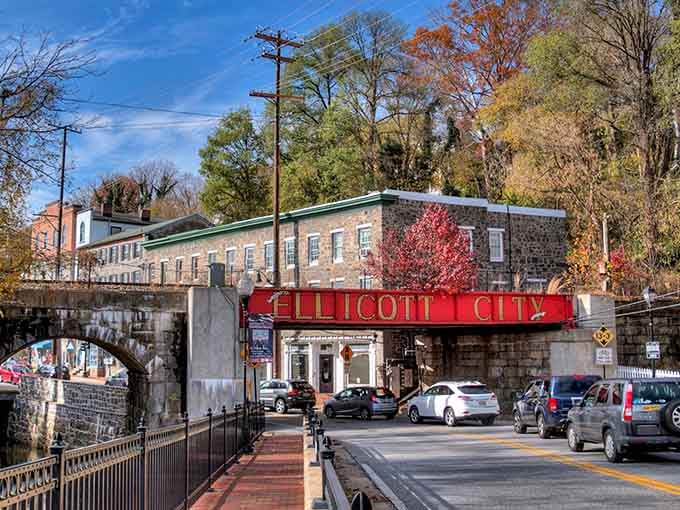 That iconic red bridge announces your arrival like a gateway to another era, minus the time machine but with better parking.