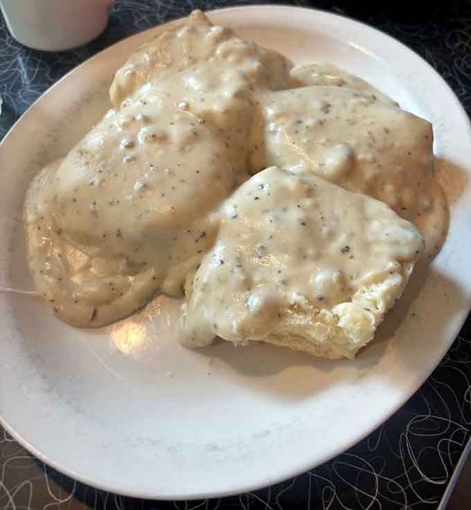 Behold: biscuits so fluffy they defy gravity, drowning in gravy that deserves its own fan club.