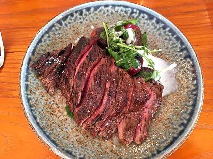 Perfectly sliced steak with that ideal pink center proves some things are worth the drive to Marshall.