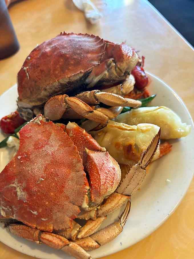 Dungeness crab piled high like edible treasure, proving that sometimes the best things in life require bibs and determination.