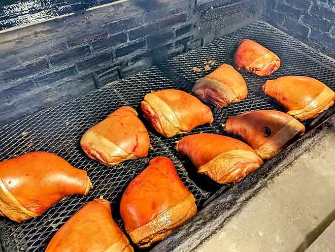 Those gorgeous mahogany-colored pork shoulders resting on the smoker grate are basically edible works of art in progress.
