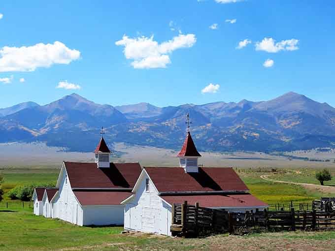 Historic ranch buildings framed by mountains remind you that this valley has stories older than your grandparents.
