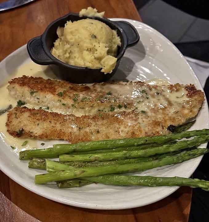 Golden Parmesan-crusted walleye with creamy garlic mashed potatoes and asparagus spears that'll make you forget every other fish dinner.