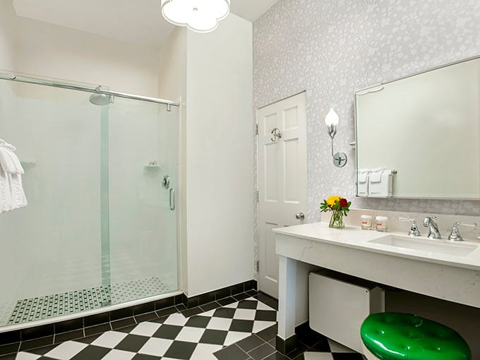 Classic black and white checkered floors meet modern convenience, where even the bathroom feels like a stylish throwback.