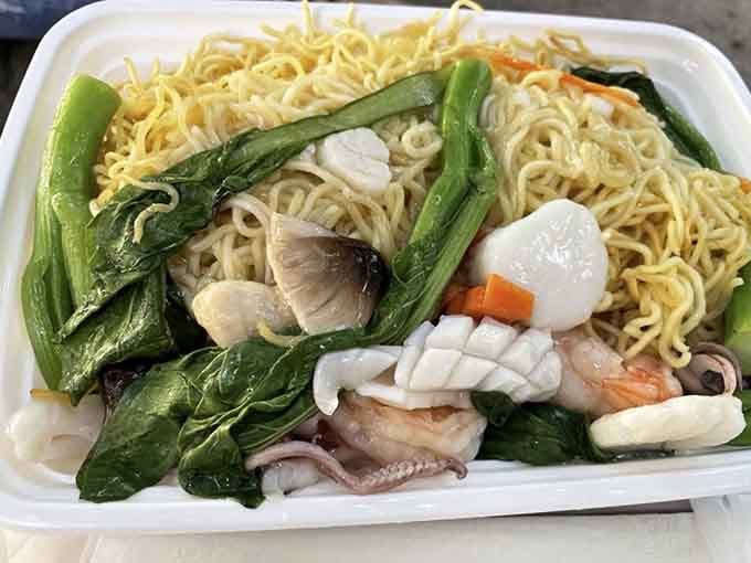Crispy noodles meet tender seafood in a dish that'll make you forget every takeout container you've ever opened.