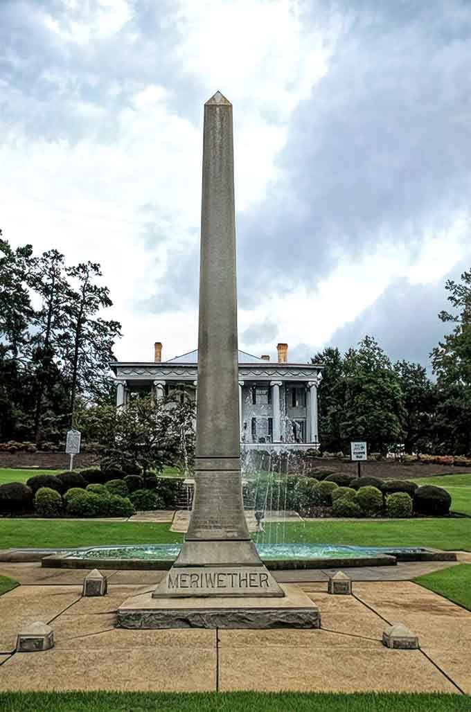 The Meriwether Monument stands proud in manicured surroundings, a stark contrast to the crumbling ghost town lurking just beyond view.