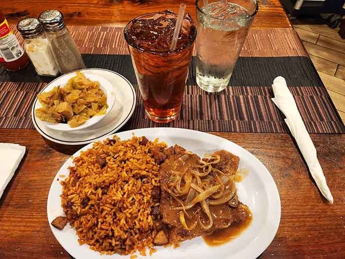 Smothered pork chops swimming in gravy alongside red rice is the definition of plate happiness.