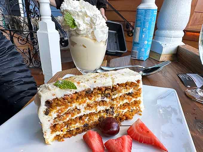 That towering carrot cake with cream cheese frosting is exactly why you saved room for dessert, no regrets allowed.