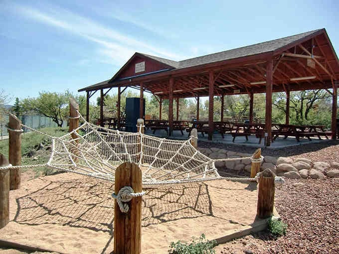 That picnic pavilion and rope climbing structure suggest someone actually remembered that kids have energy to burn off.